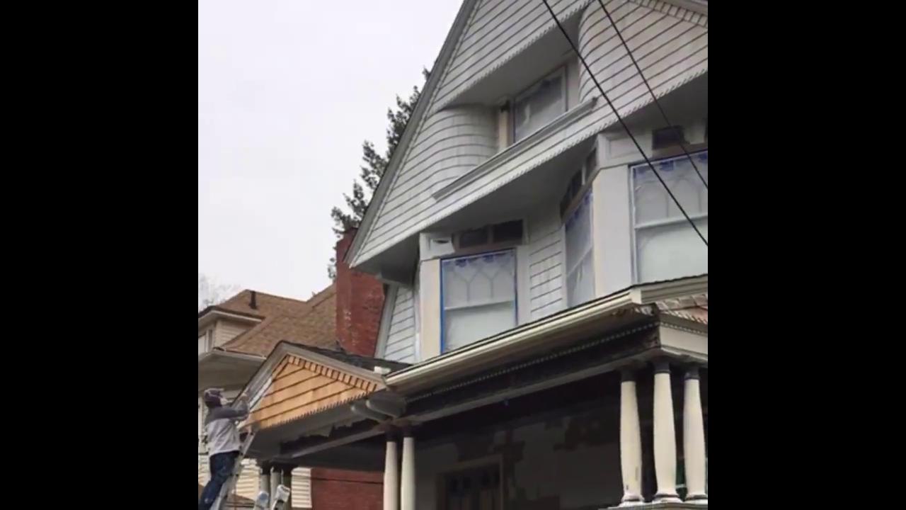 Exterior roof edge painting with spray gun producing smooth and even ...