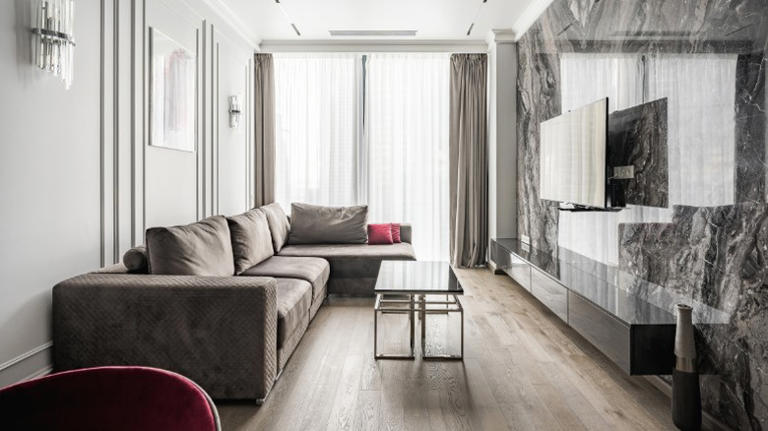 The designer trick that makes a narrow living room feel way bigger