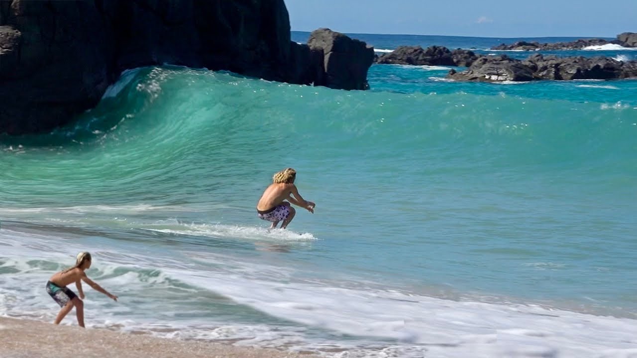 Attempting to skimboard Waimea shorebreak