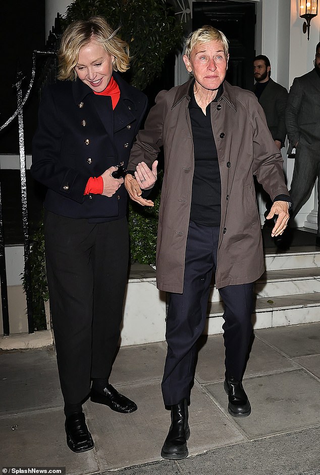 Ellen DeGeneres looks animated as she is helped by her wife Portia de Rossi