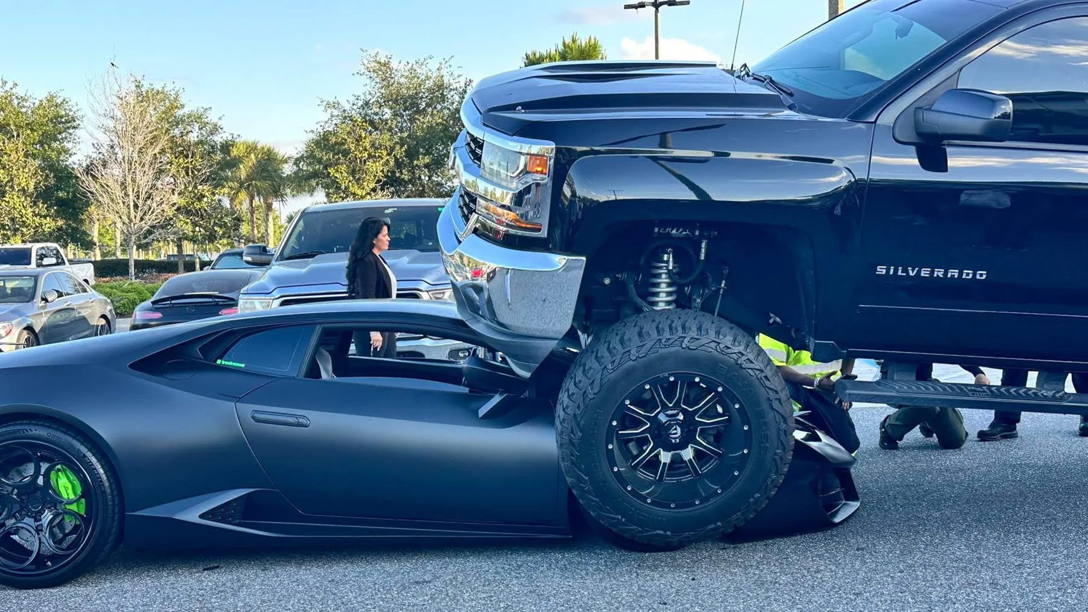 Lifted truck drives over Lamborghini in Florida lot