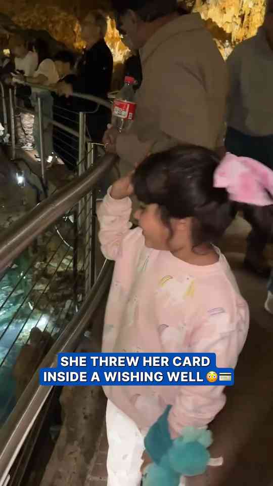 Young child drops debit card into water in playful moment