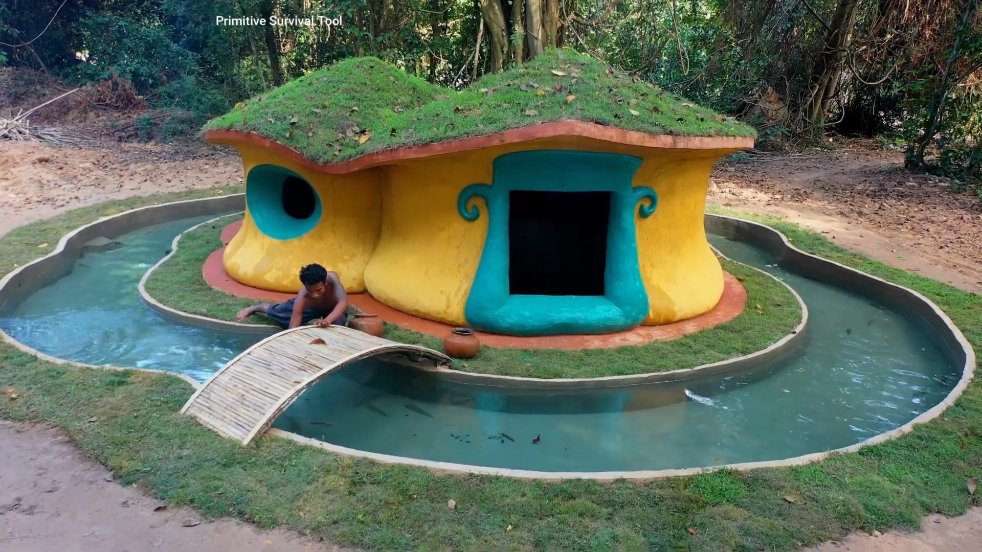 Watch two men build a safe shelter with a fish pond beneath the ground