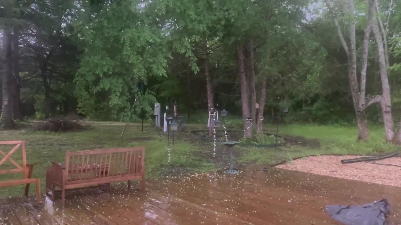 Hail slowly covers wooden deck during storm in Elkins, Arkansas, USA
