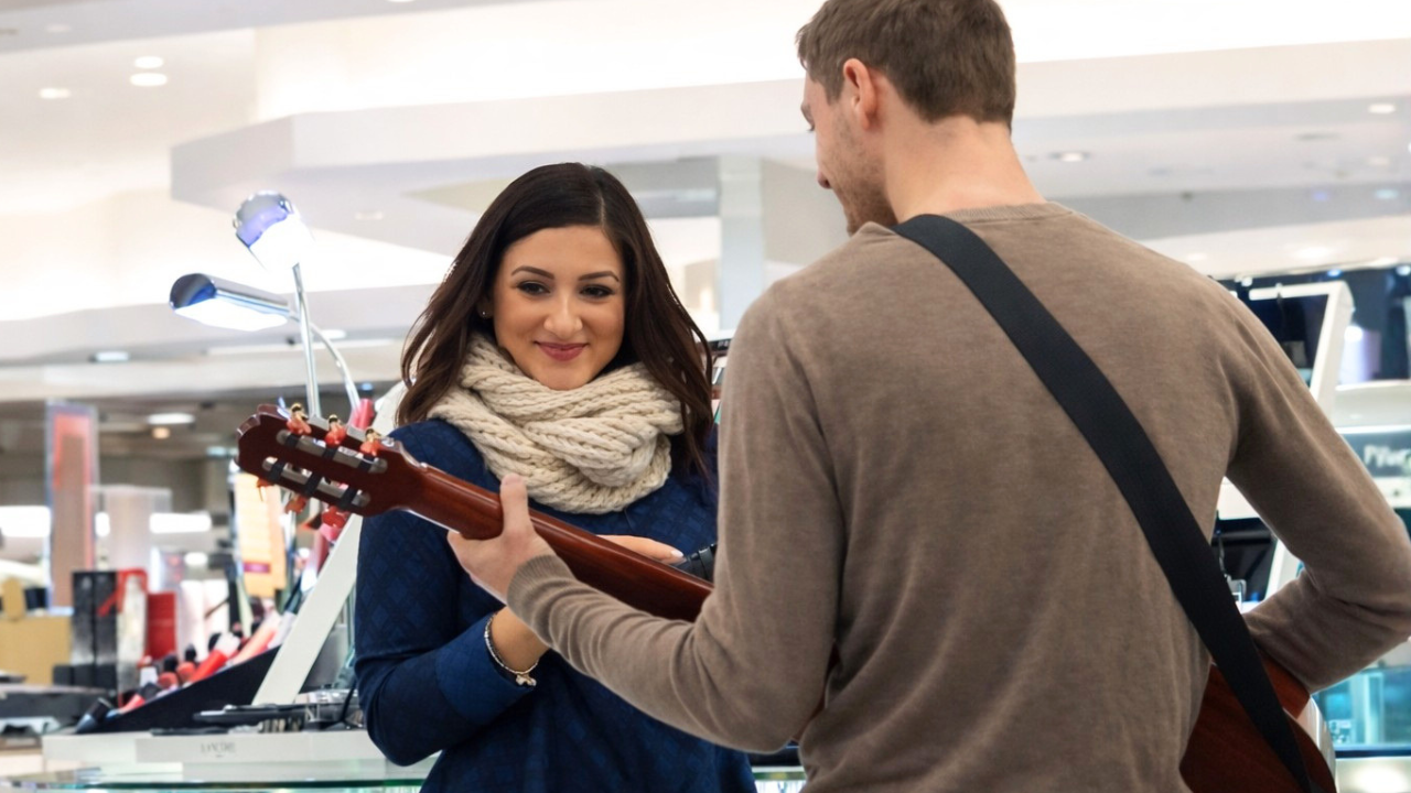 A man sings to women in public for their numbers
