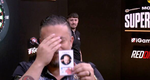 Darts star holds back tears over son's death on emotional return after ...