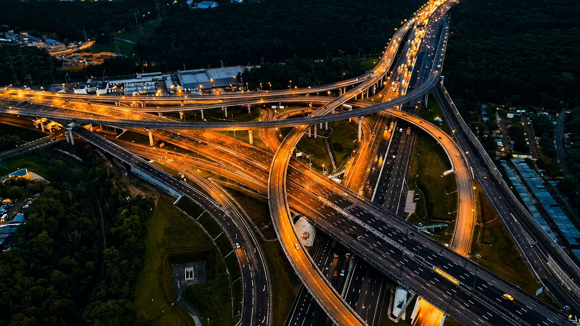 Busy highway network with glowing traffic lights from above