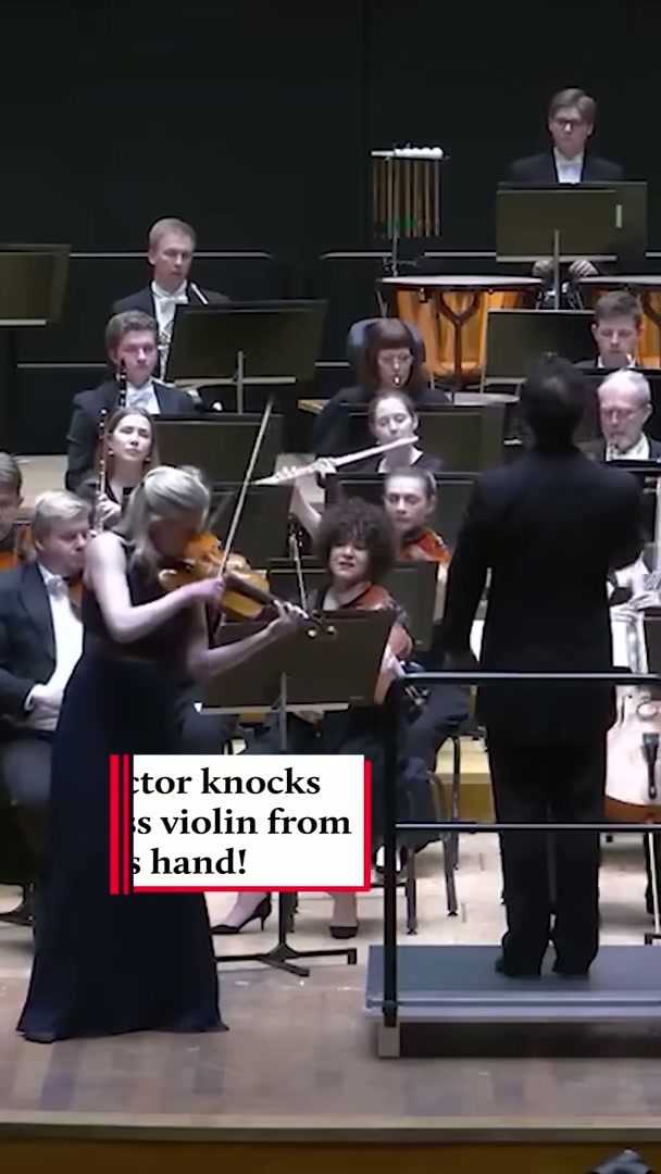 Watch the horrifying moment conductor knocks priceless violin out of ...