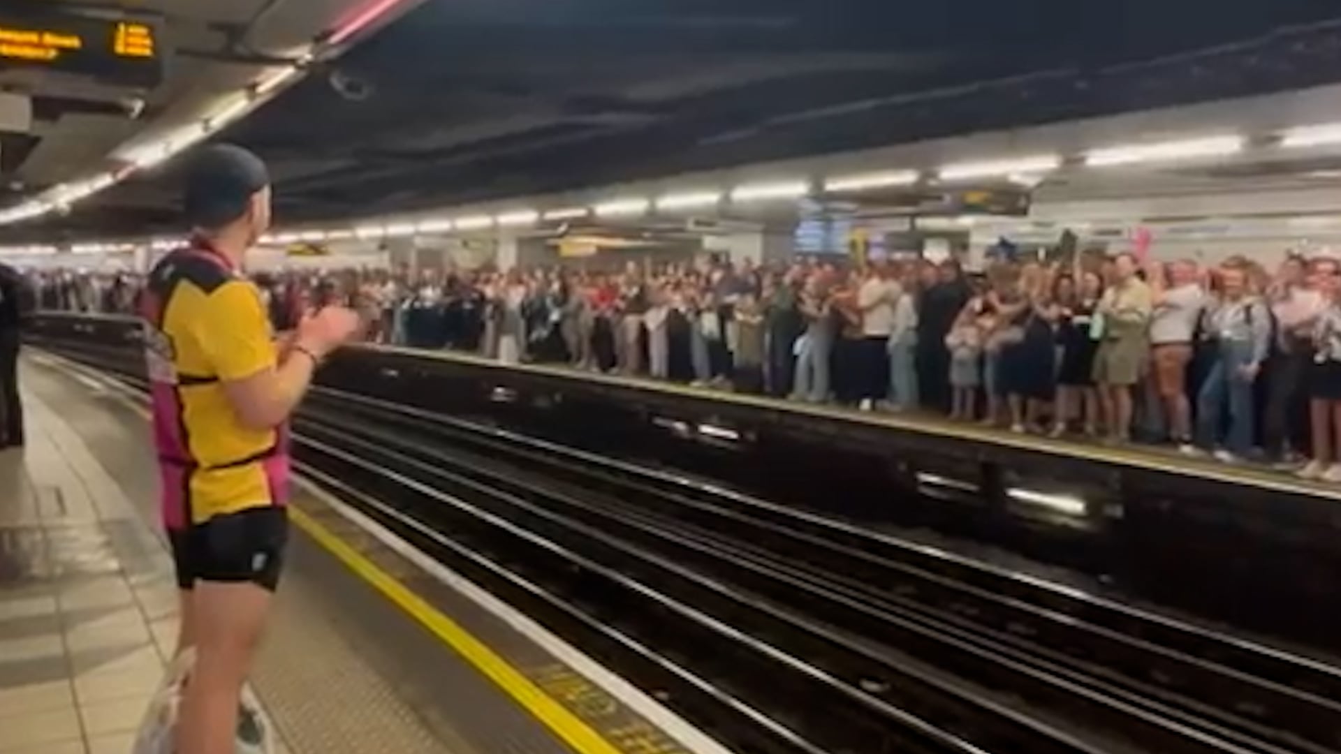 Magical moment tube passengers give marathon runner round of applause