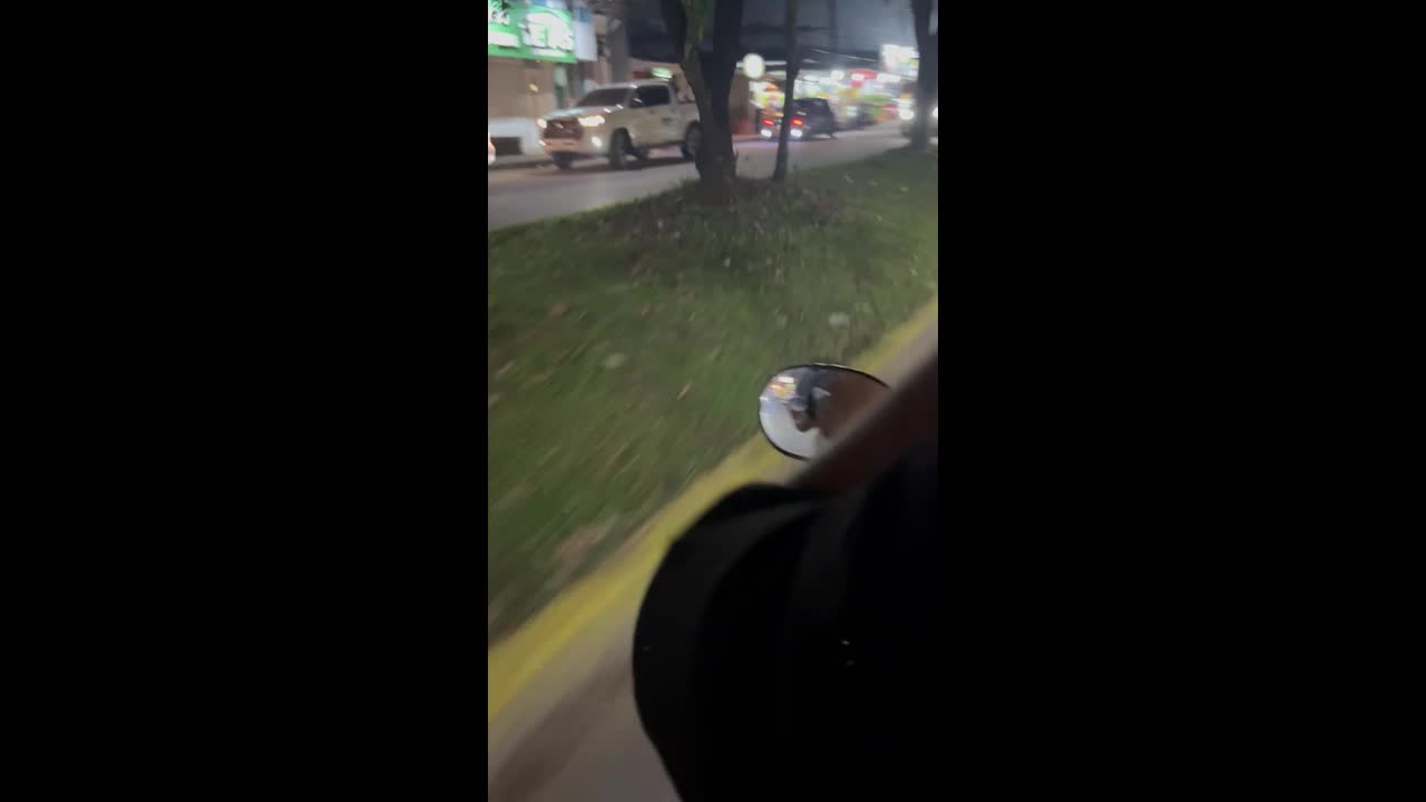 Dog sits on parked motorcycle with paw on throttle in Mocoa, Colombia