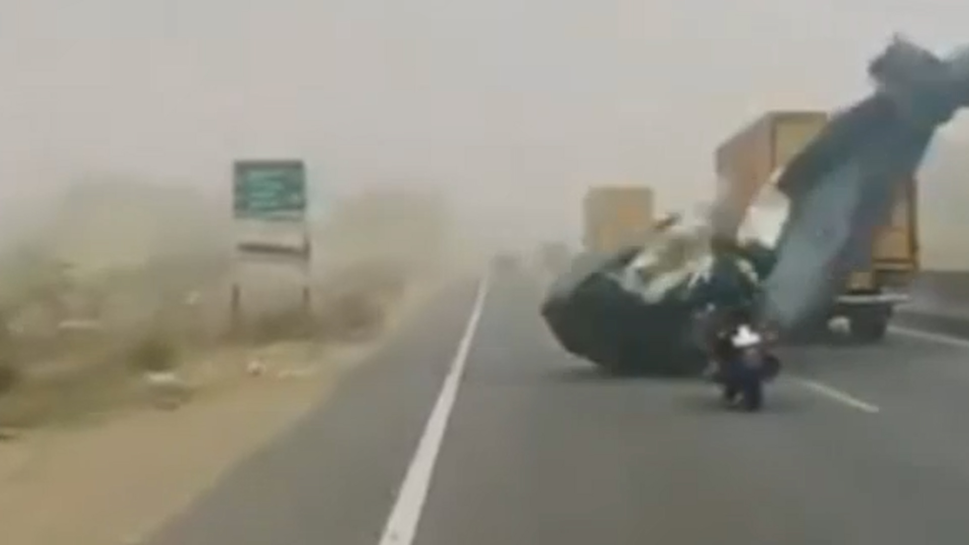 Motorcyclist crashes after windblown banner blocks road in India
