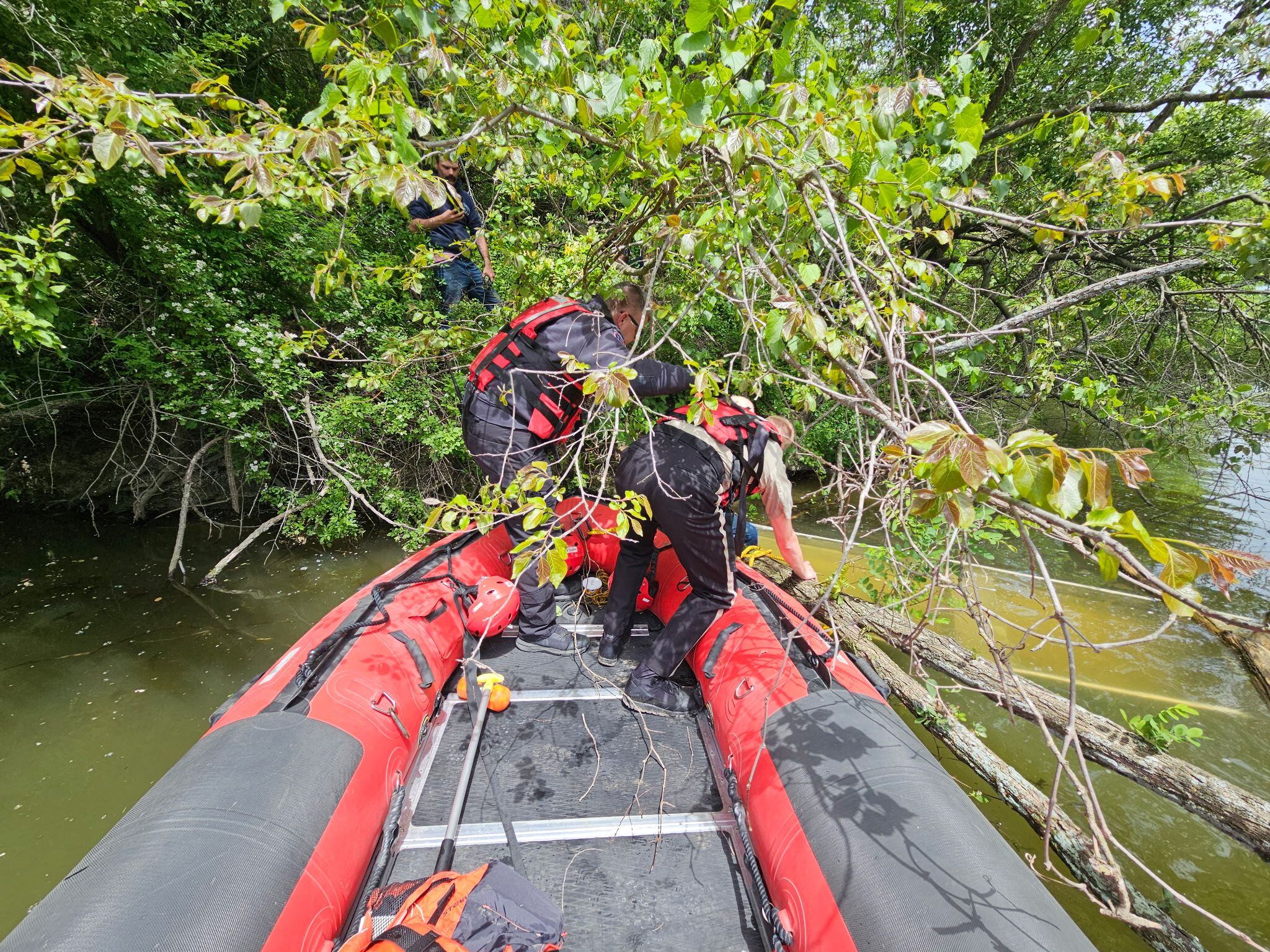 Crews rescue person clinging to tree after falling from boat at Peabody ...