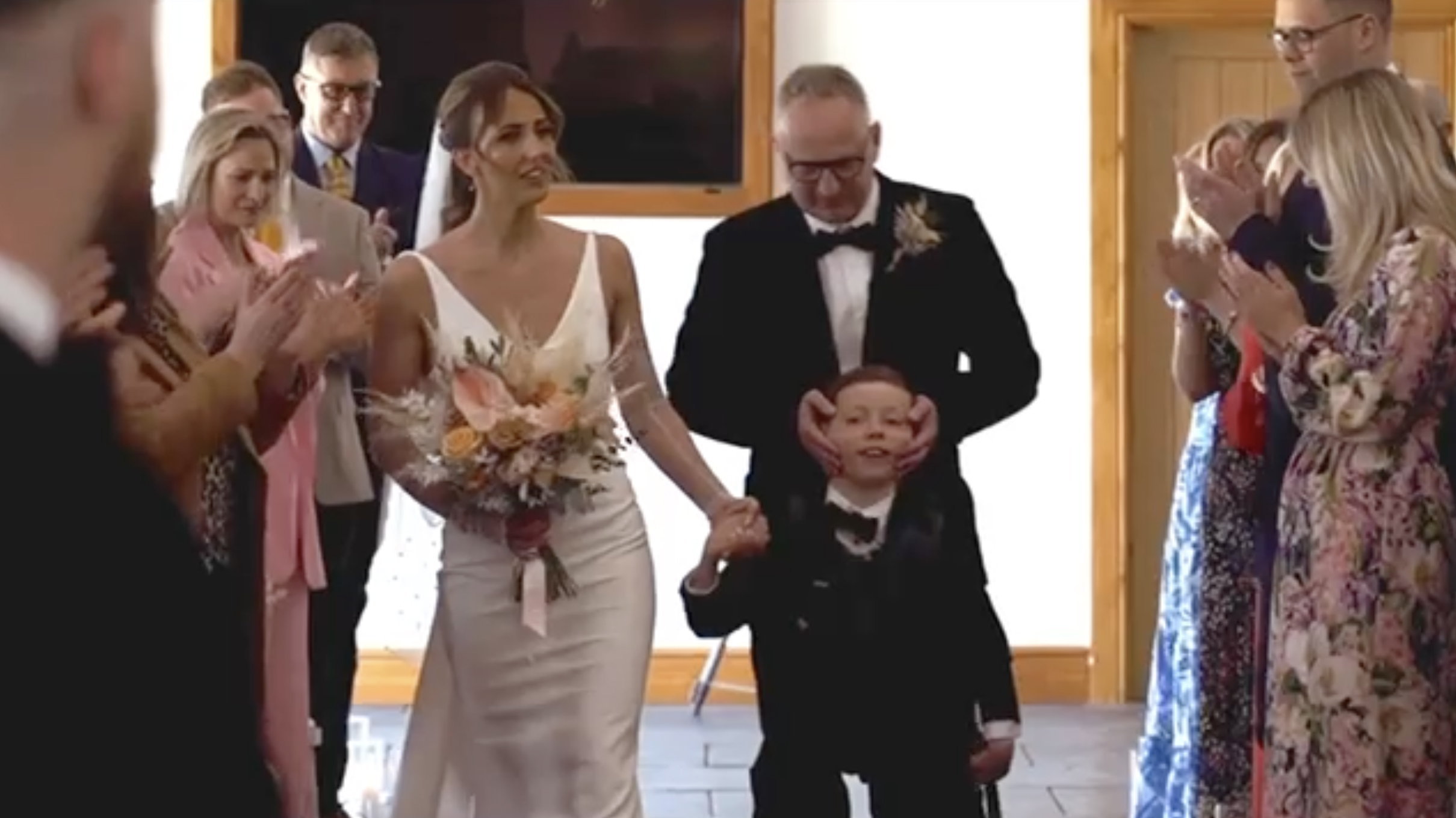 Boy defies odds to walk mum down aisle with special harness