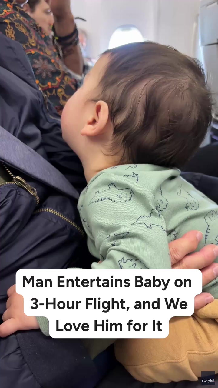 Man entertains a restless baby on 3-hour flight