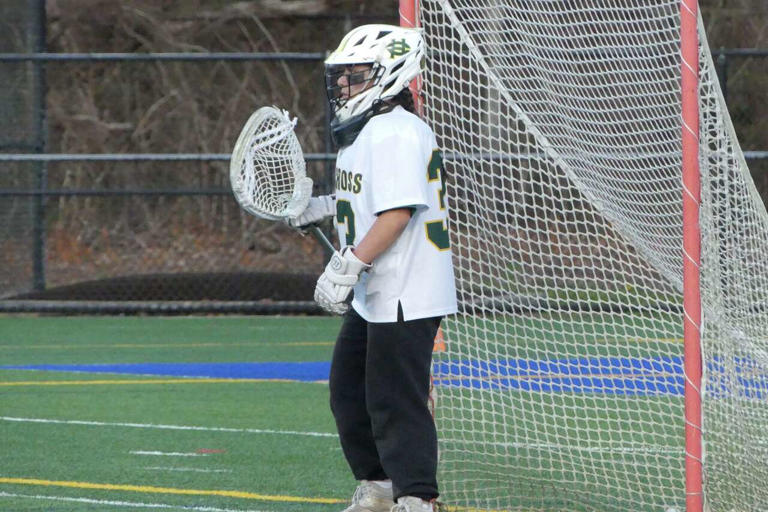 The only girl on the field for Holy Cross is stopping shots for its ...