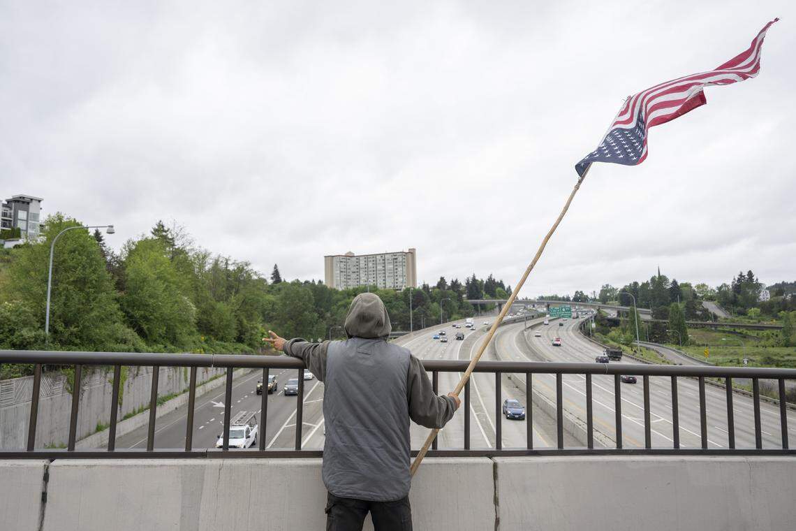 Who is that man waving an upside-down American flag near the Tacoma ...