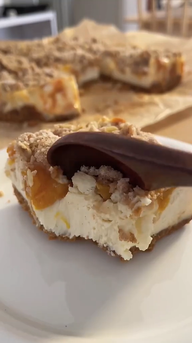 Peach crumble cheesecake bars that look bakery perfect