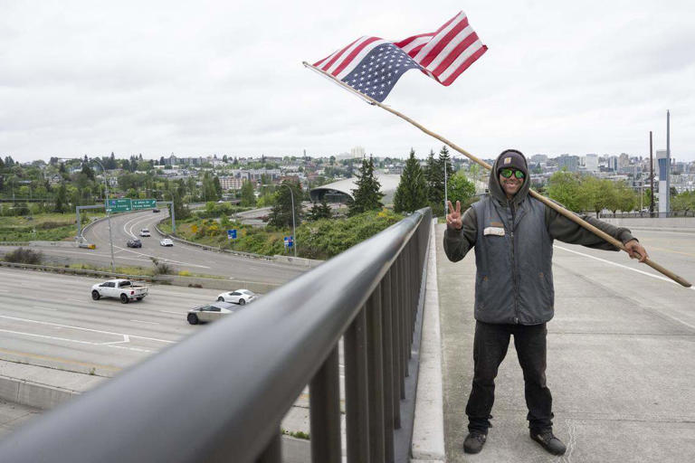 Who is that man waving an upside-down American flag near the Tacoma ...