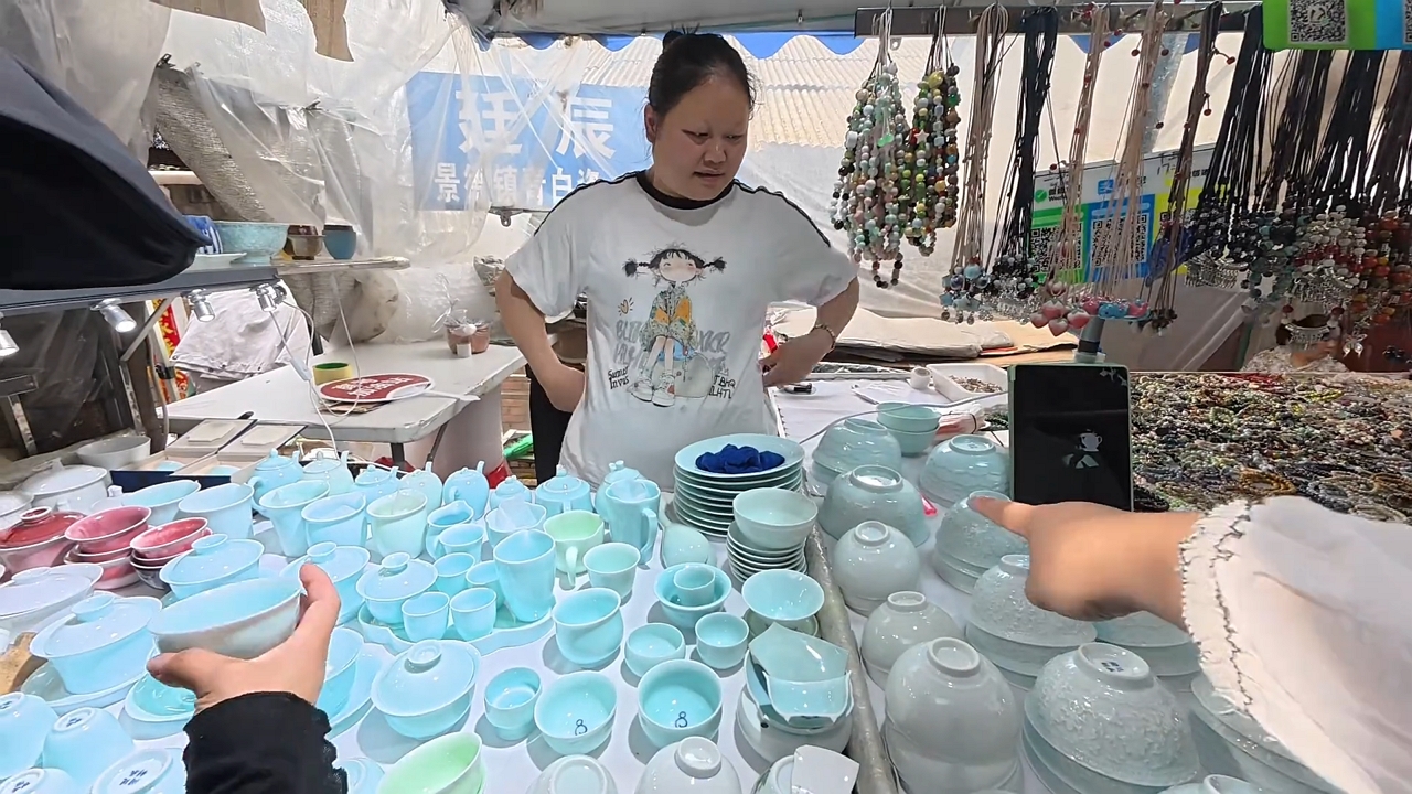 Woman demonstrates musical ceramic bowl in Jiangxi, China