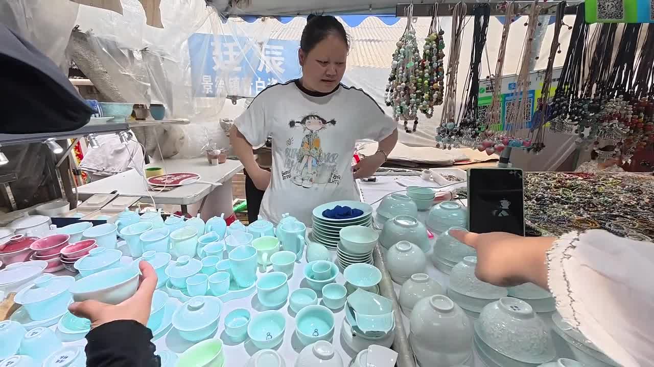 Woman demonstrates musical ceramic bowl in Jiangxi, China