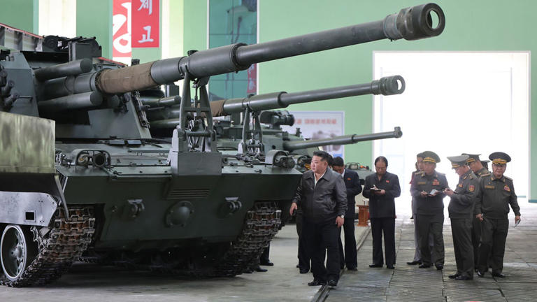 North Korea's Kim Jong Un and daughter eat with crew on new warship