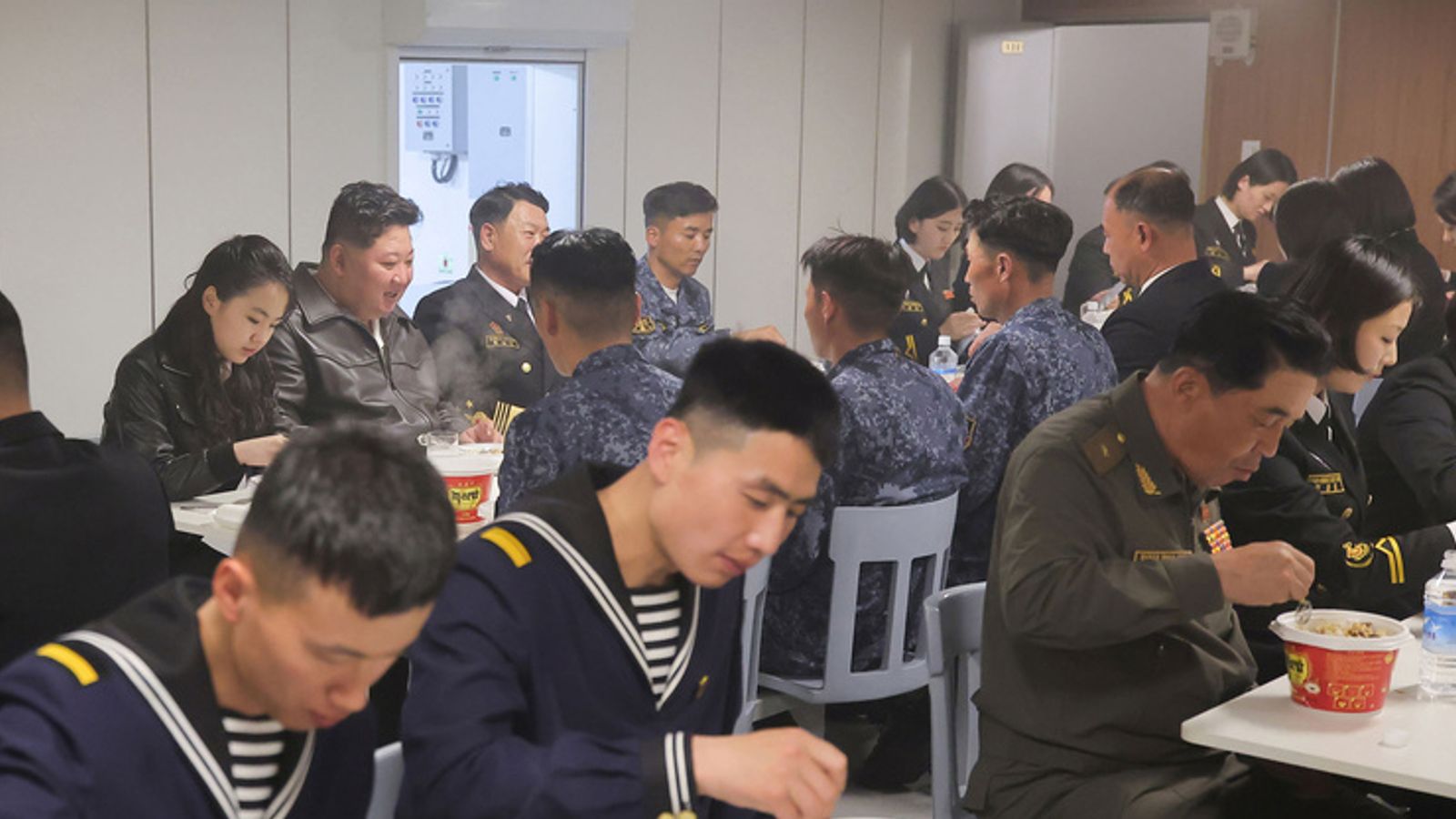 North Korea's Kim Jong Un and daughter eat with crew on new warship