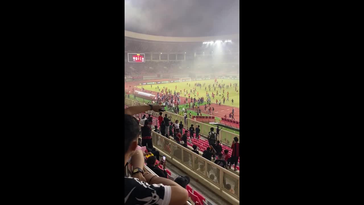 Football fans storm pitch and smash VAR monitors when team loses out on ...