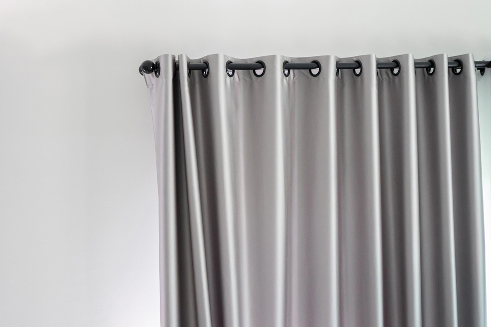 How to hang curtains to make windows look bigger