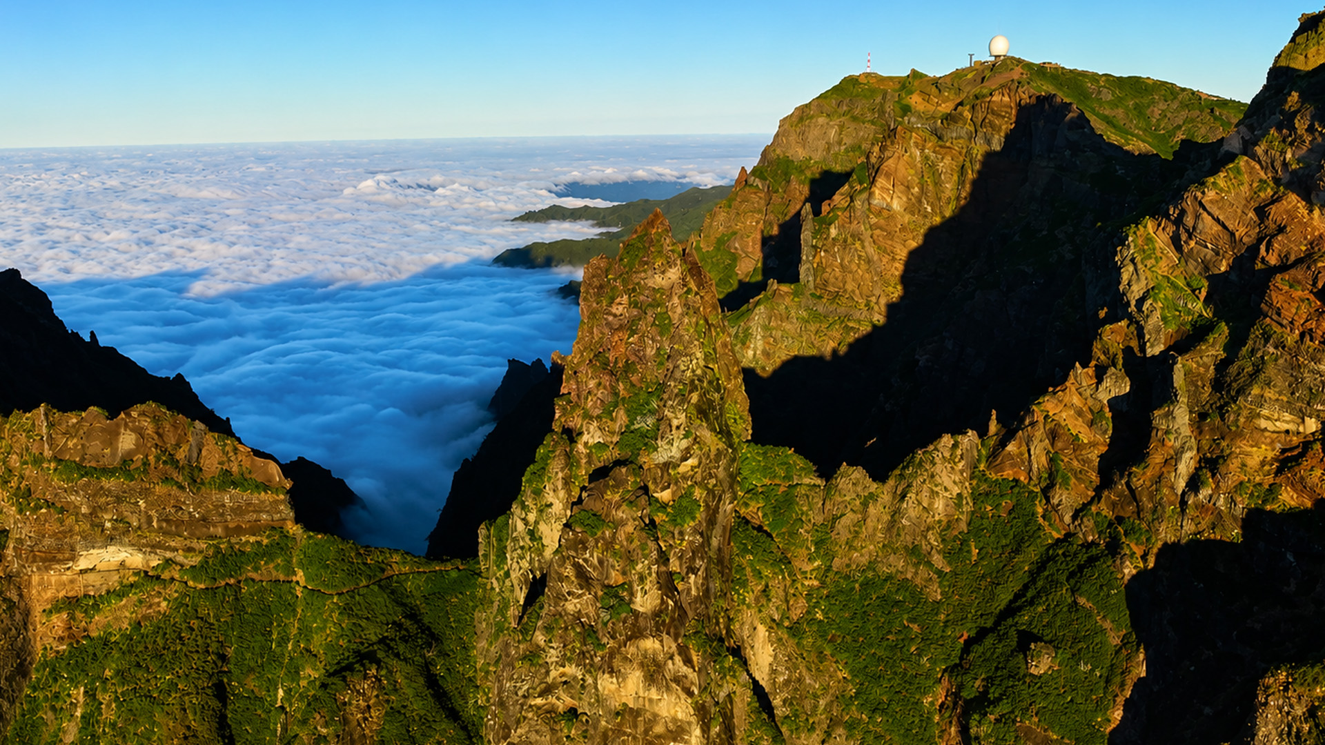 A mountain peak rising above the clouds