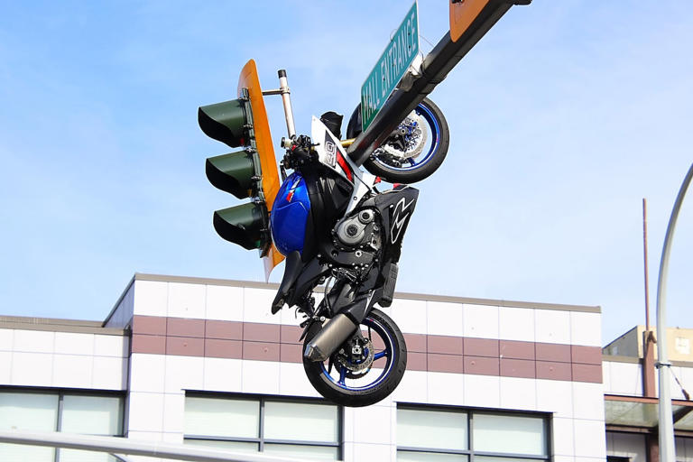 Motorcyclist seriously injured after crash leaves bike dangling from ...