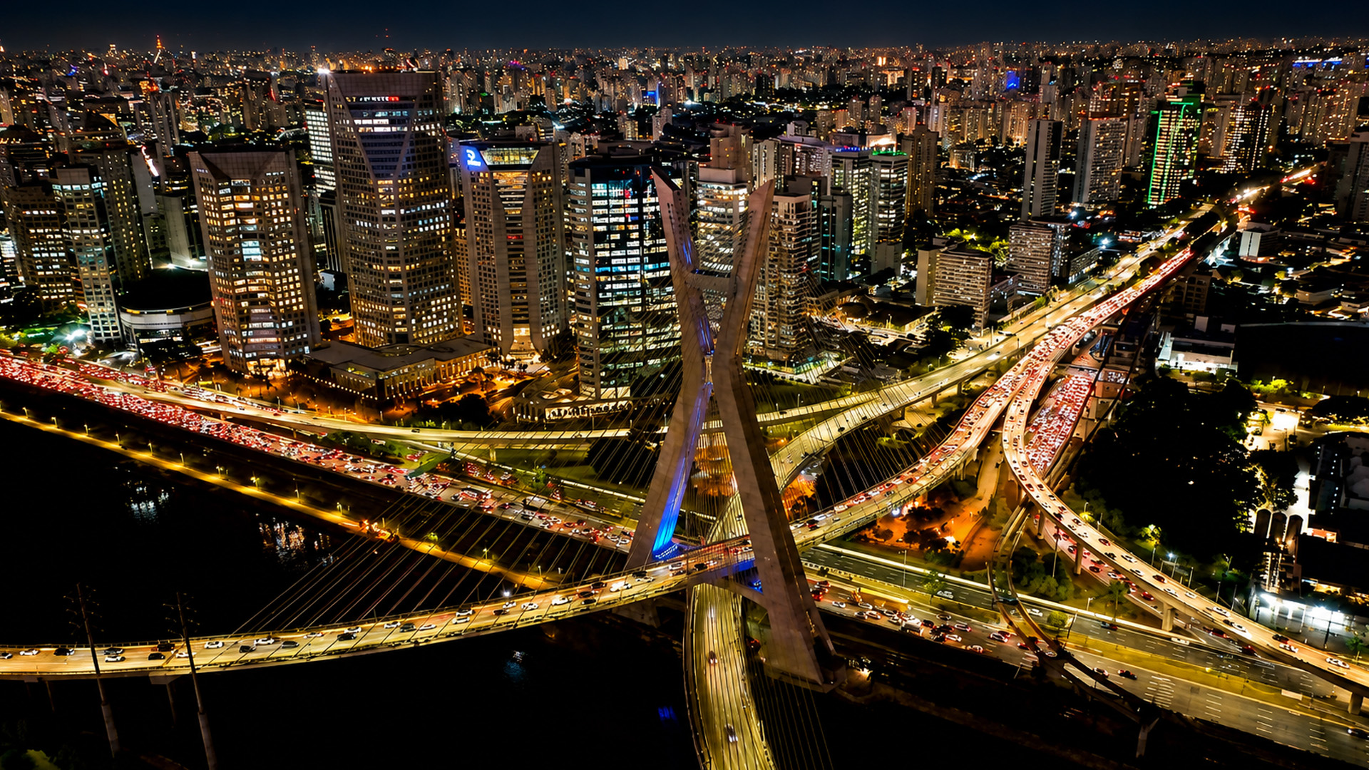 A massive city skyline glowing across São Paulo at night