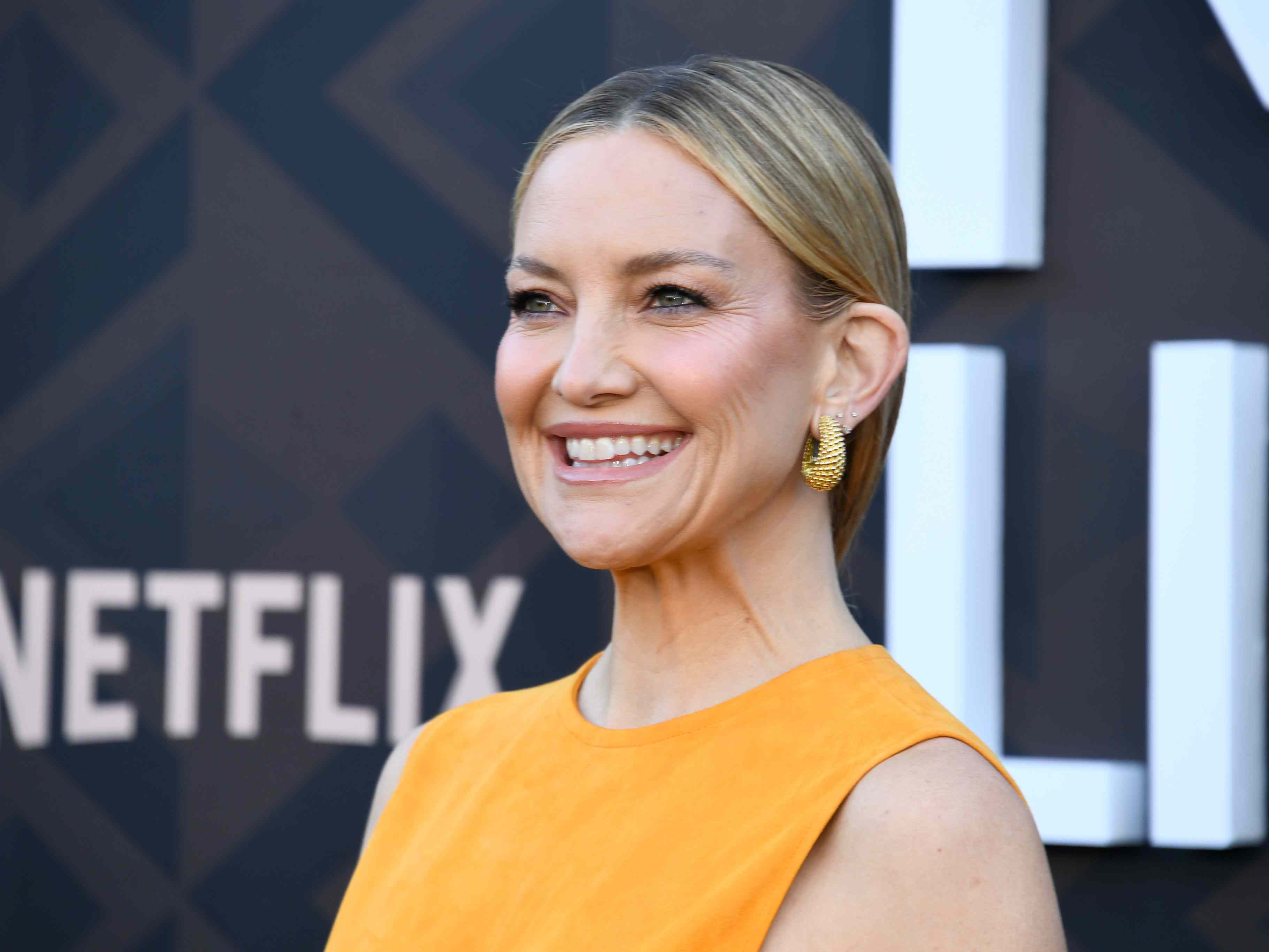 Kate Hudson switches up her signature hair for giant 70s disco fluffy ...