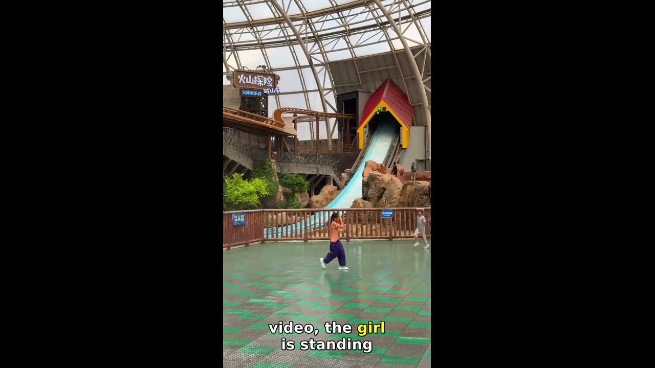 Girl stands still for water splash at amusement park in Tianjin, China