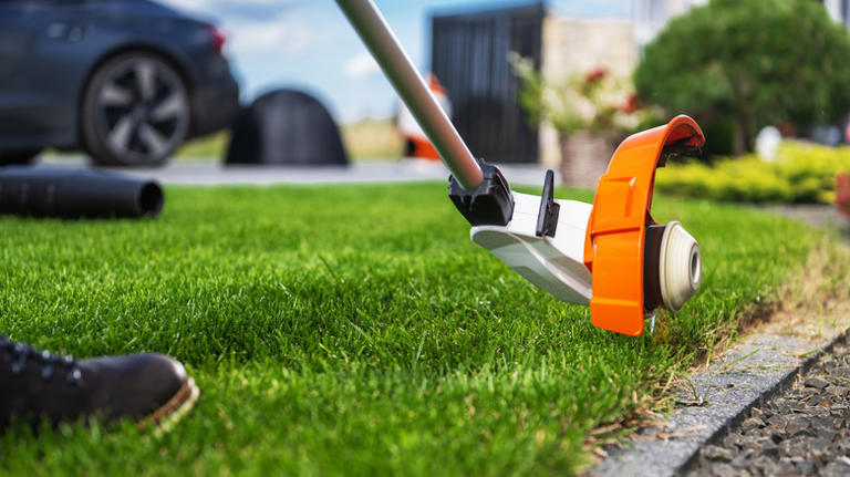 The weedeating tip that makes driveway and lawn edges look sharp