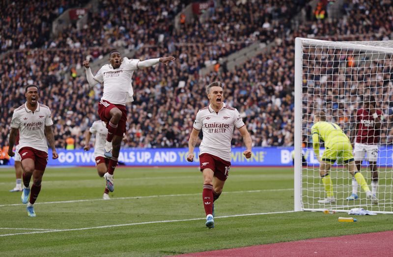 Soccer-Arsenal survive huge scare to edge towards title