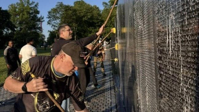 Photos | Volunteers wash Vietnam Veterans Memorial on Mother's Day in DC