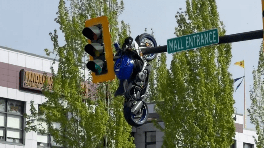 Motorcycle seen hanging off traffic light after crash