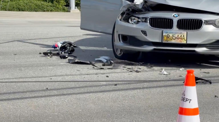 Motorcycle flies onto traffic light pole after head-on collision with ...