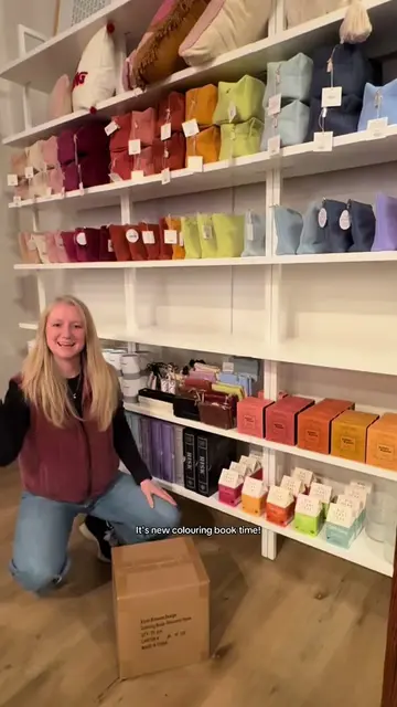 Restocking my rainbow coloring book wall at the shop