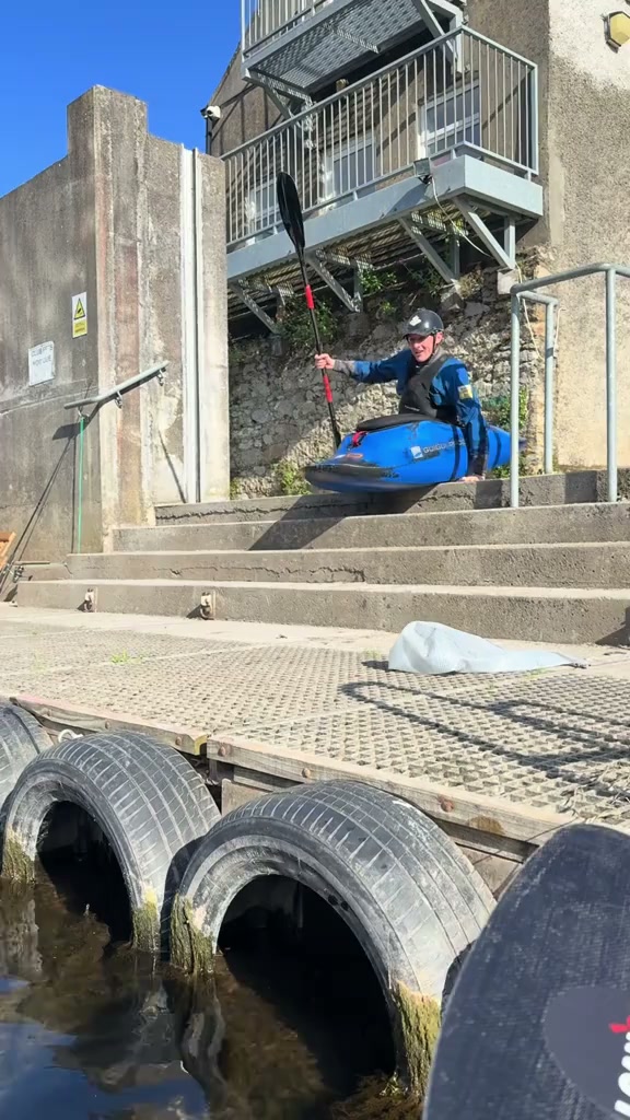 Kayak stair drop turns into a surprise flip and smooth roll