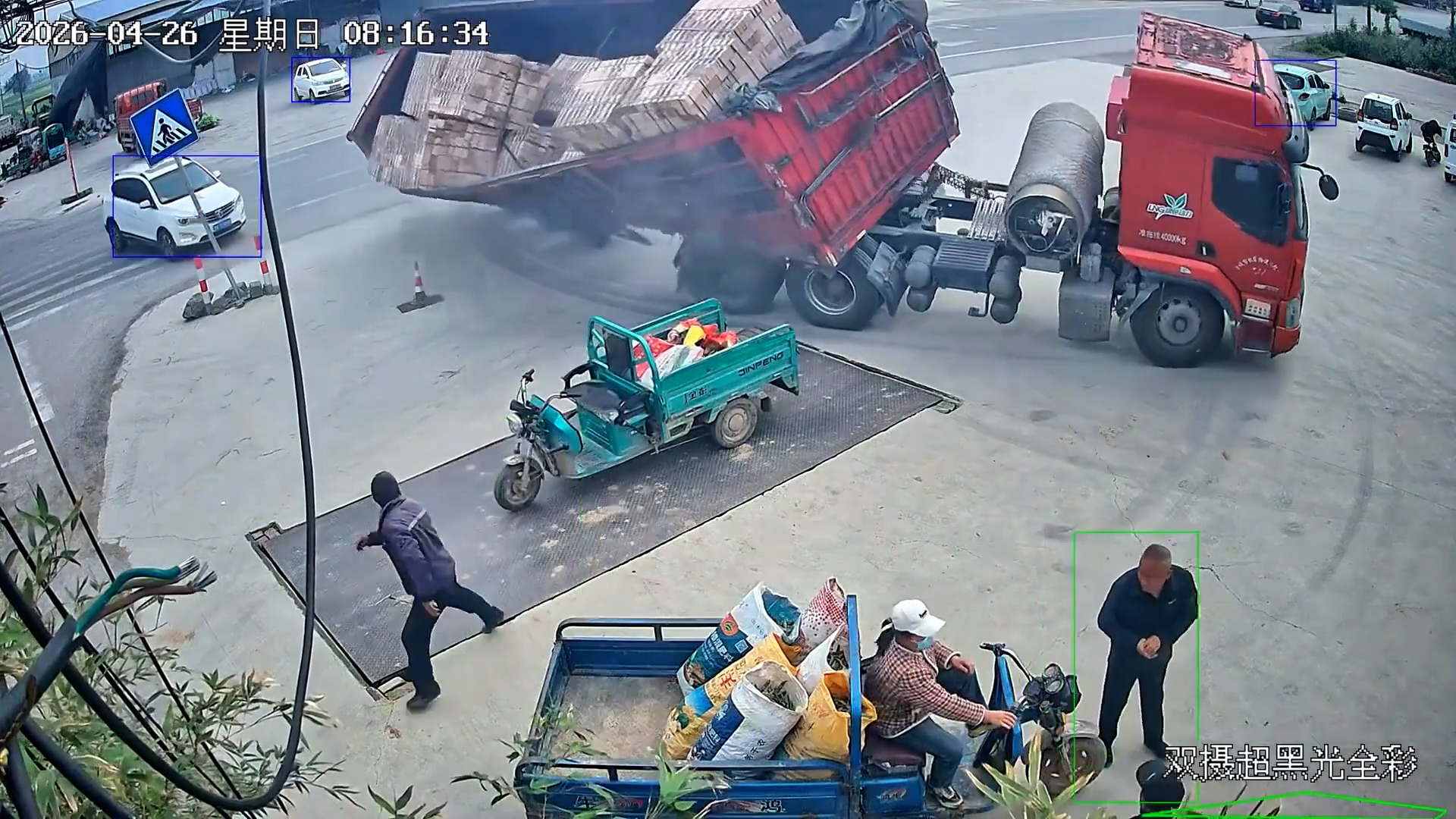Brick-laden truck overturns after sharp turn narrowly missing rider