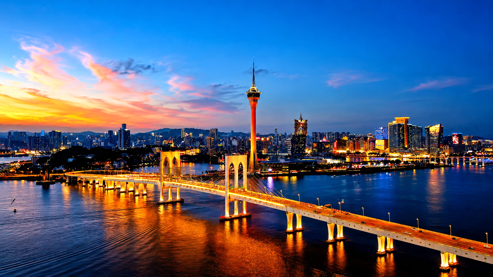 Macao’s tower and waterfront lights glowing across the night skyline