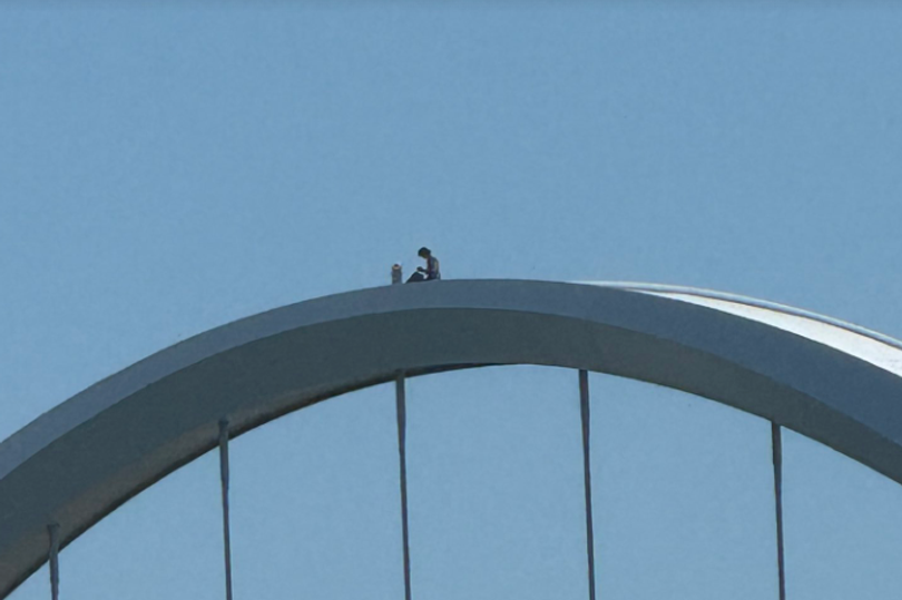Terrifying scenes as May Day protester spotted on top of Washington DC ...