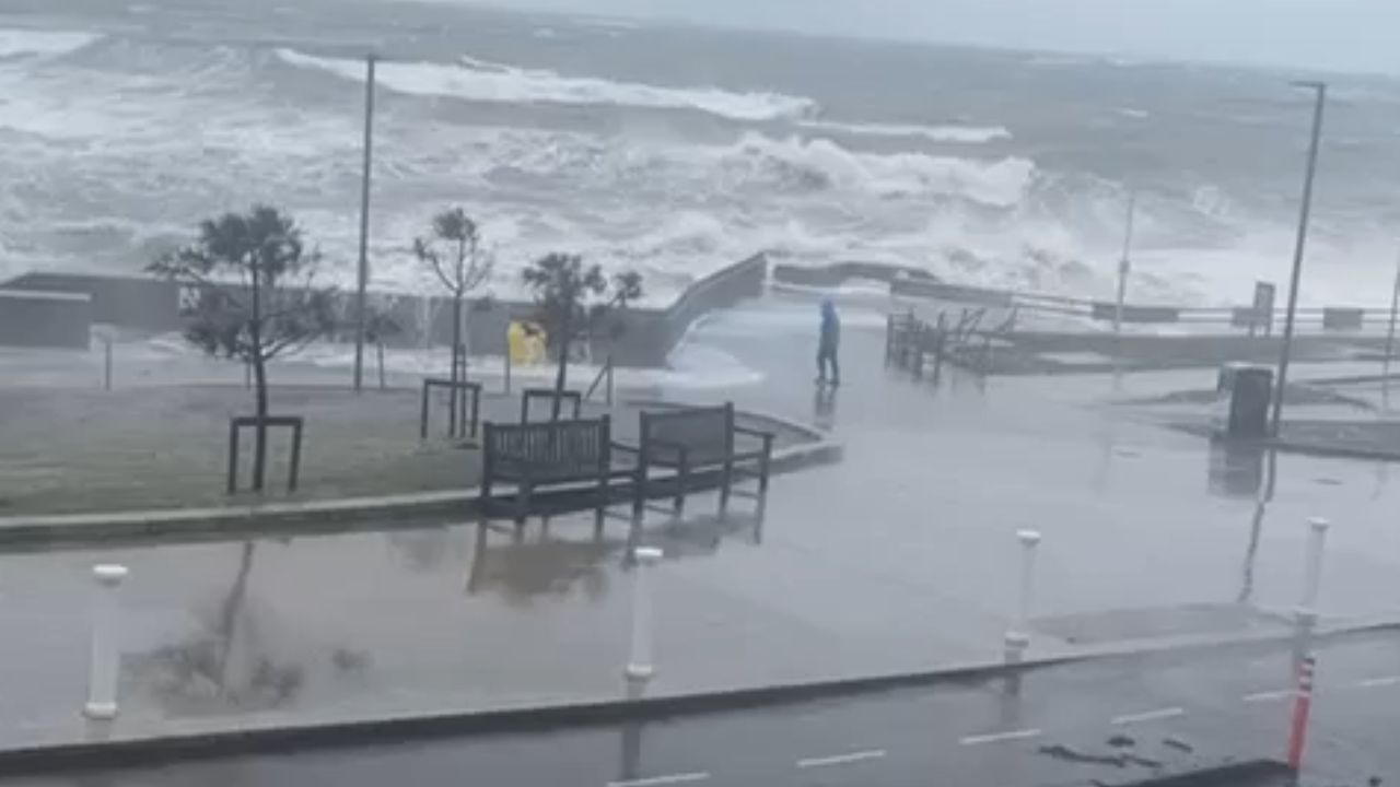 High tide sends a sudden spray over the seawall