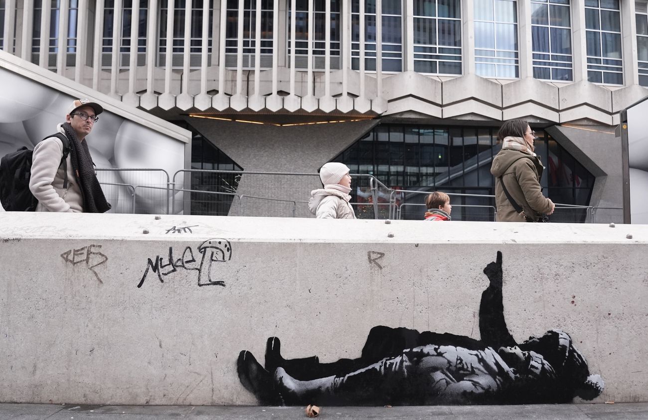 Attributed to Banksy, a new statue of a suited man, blinded by a flag ...