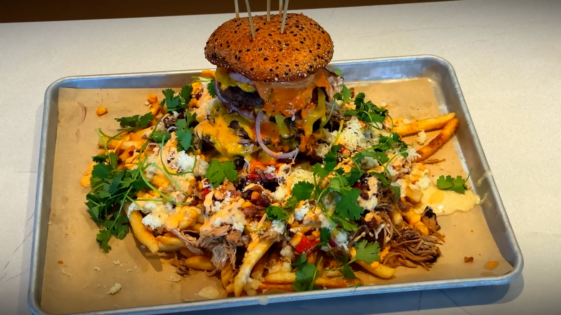 Man attempts insane 8 patty burger challenge with loaded fries