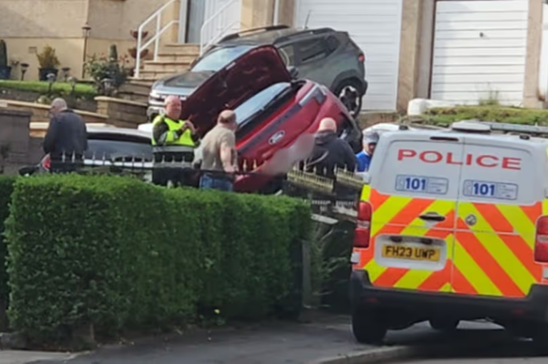 Police rush to crash in Glasgow residential street as car flips over
