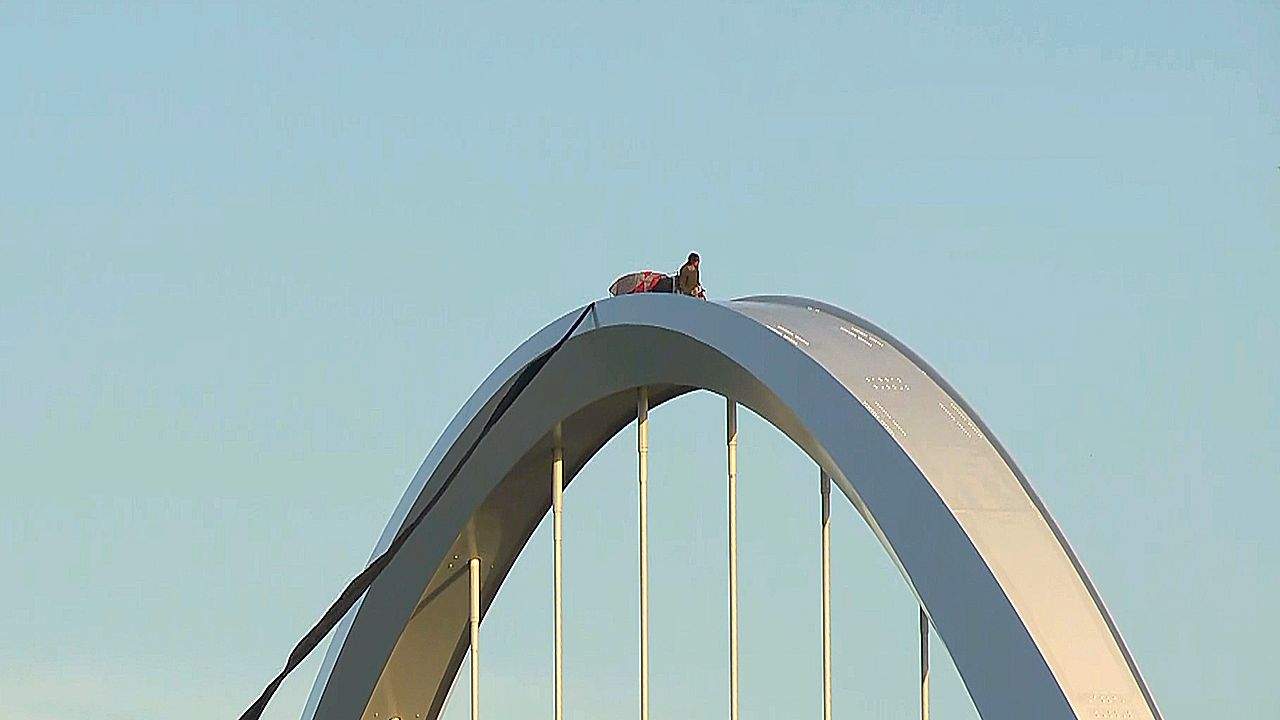 Activist climbs Douglass Memorial Bridge in DC to protest Iran war and AI