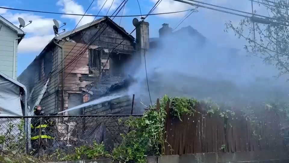 Massive fire tears through building in Queens