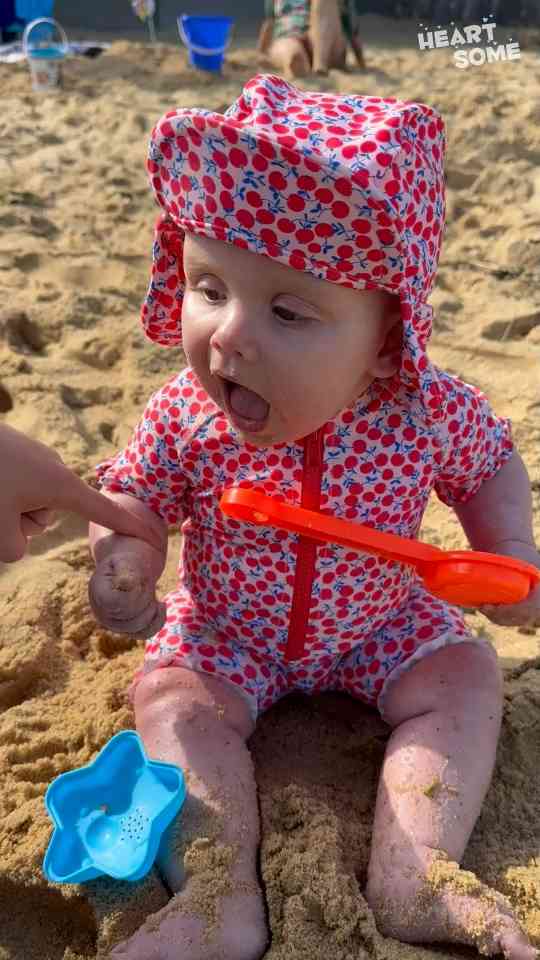 Little toddler gets angry because mom won’t let her eat beach sand ...